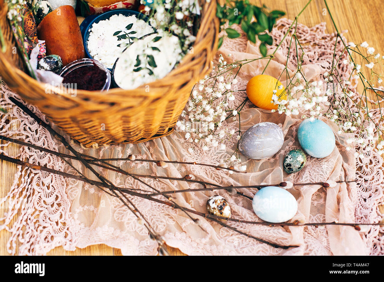 Stylish Easter basket with modern eggs, easter bread cake, ham, beets ...