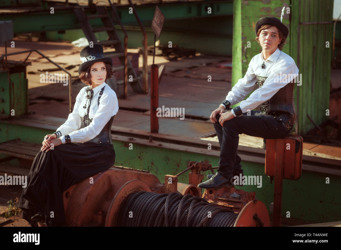 People in the style of steampunk in retro costumes on the mechanisms of ...