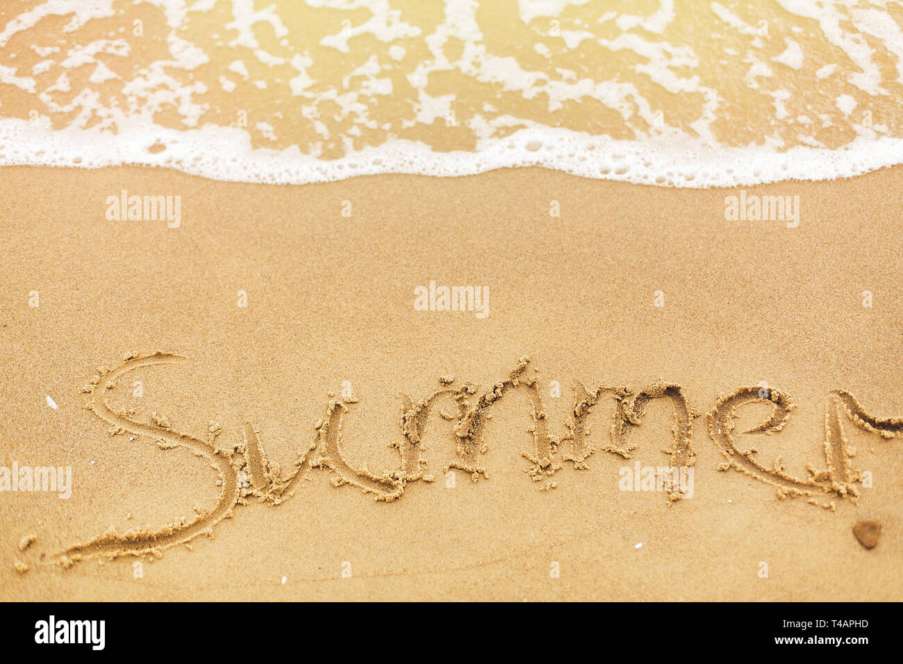 Summer text written on sandy beach and sea waves. Relaxing on tropical ...