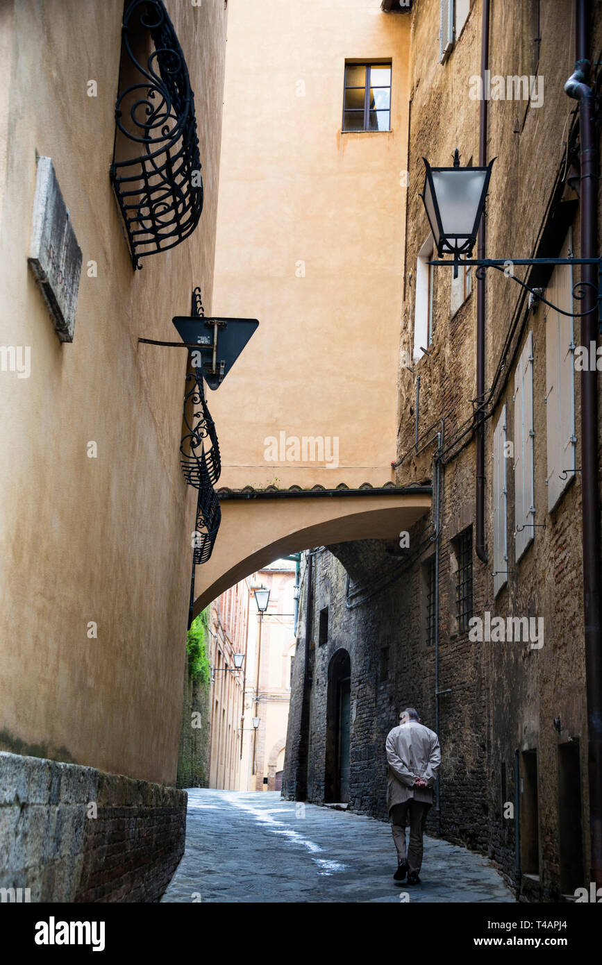 Medieval city of Siena, Italy and La Passeggiata, a walk or stroll ...