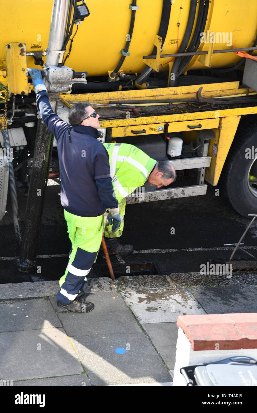 Drainage workers using heavy equipment to clear drains Stock Photo - Alamy
