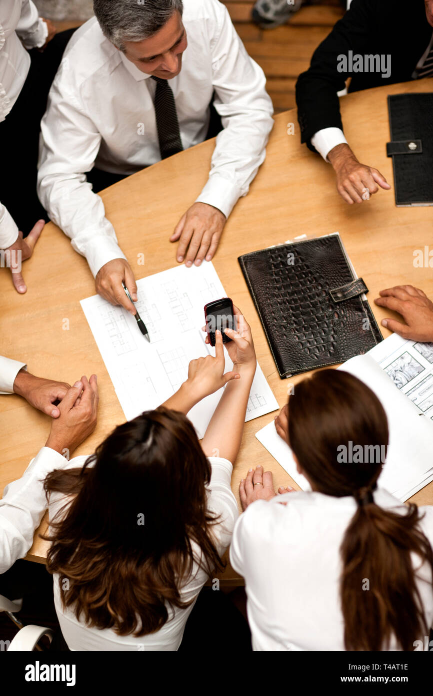 Group of architects brainstorming around a conference table Stock Photo ...