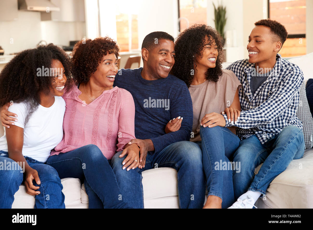 Parents relaxing at home with their teen and young adult kids Stock ...