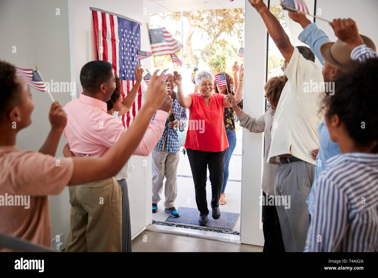 Arriving guests are welcomed at a three generation black family ...