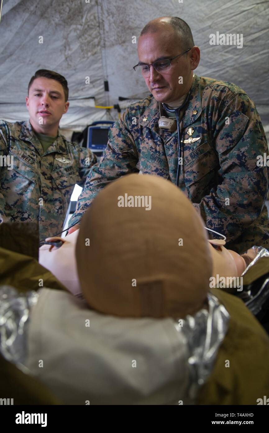 U.S. Navy Lt. Cmdr. Clair Smith, left, a doctor with 2nd Medical ...