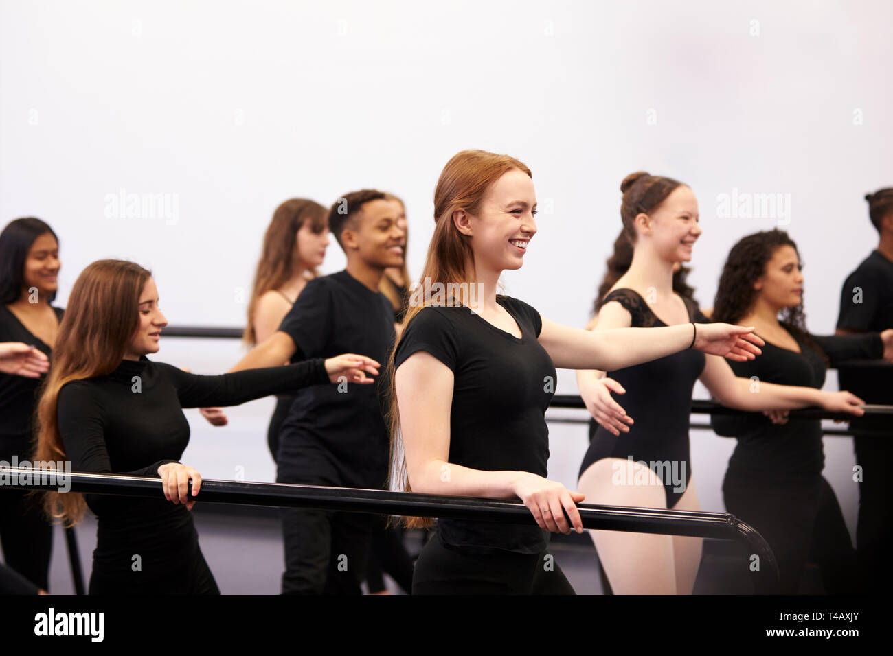 Male And Female Students At Performing Arts School Rehearsing Ballet In ...