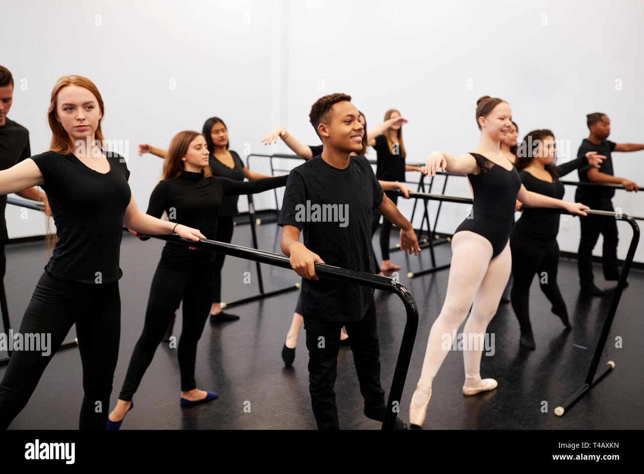 Male And Female Students At Performing Arts School Rehearsing Ballet In ...