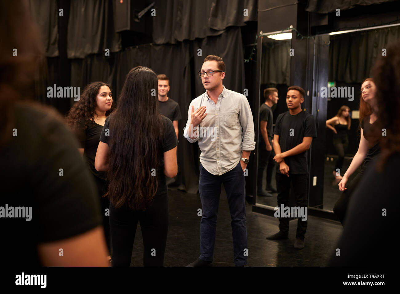 Teacher With Male And Female Drama Students At Performing Arts School ...