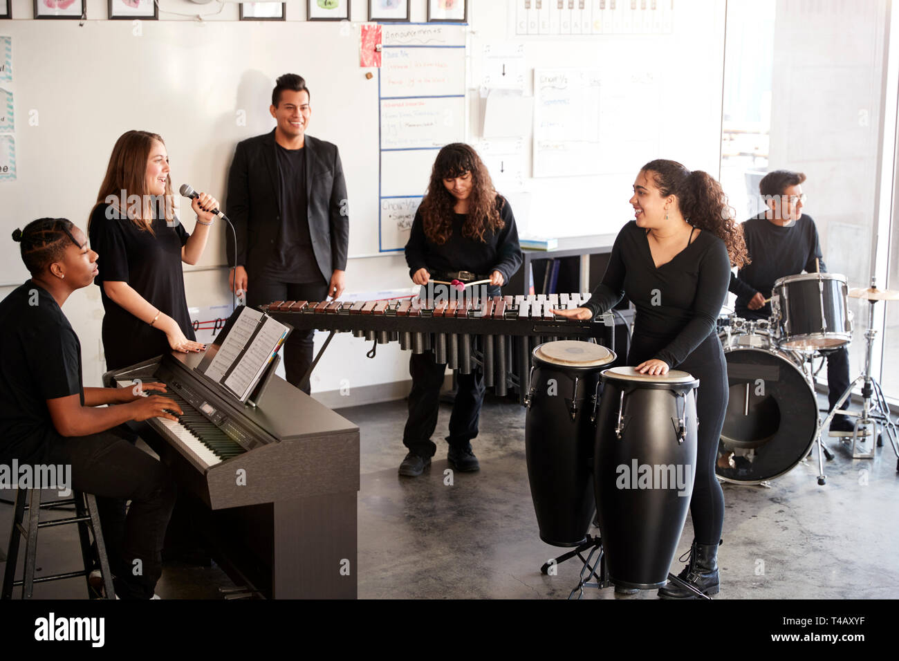 Students At Performing Arts School Playing In Band At Rehearsal With ...