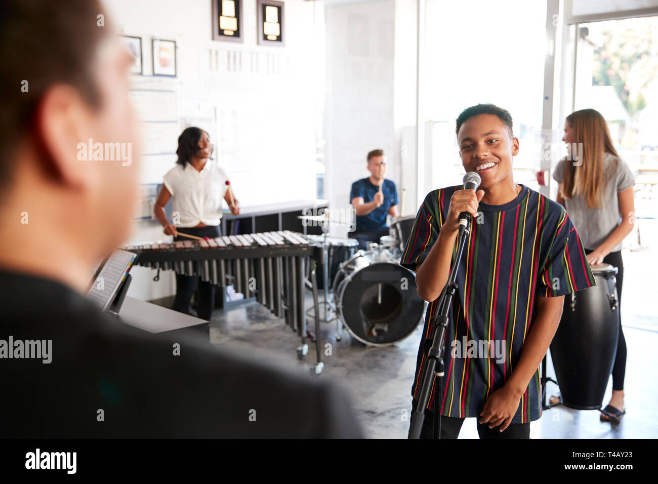 Students At Performing Arts School Playing In Band At Rehearsal With ...