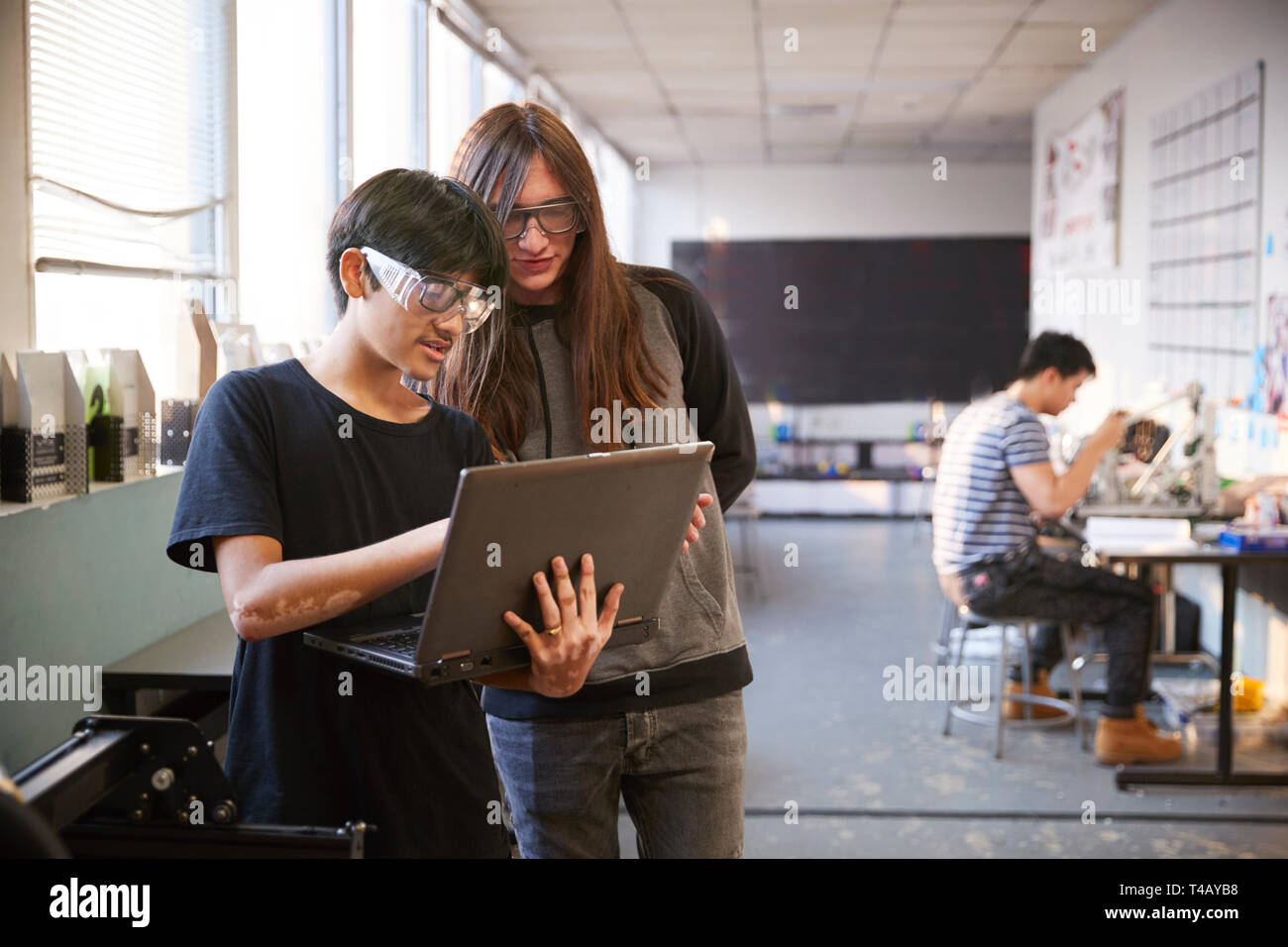 Two Male College Students Using Laptop Computer In Science Robotics Or ...