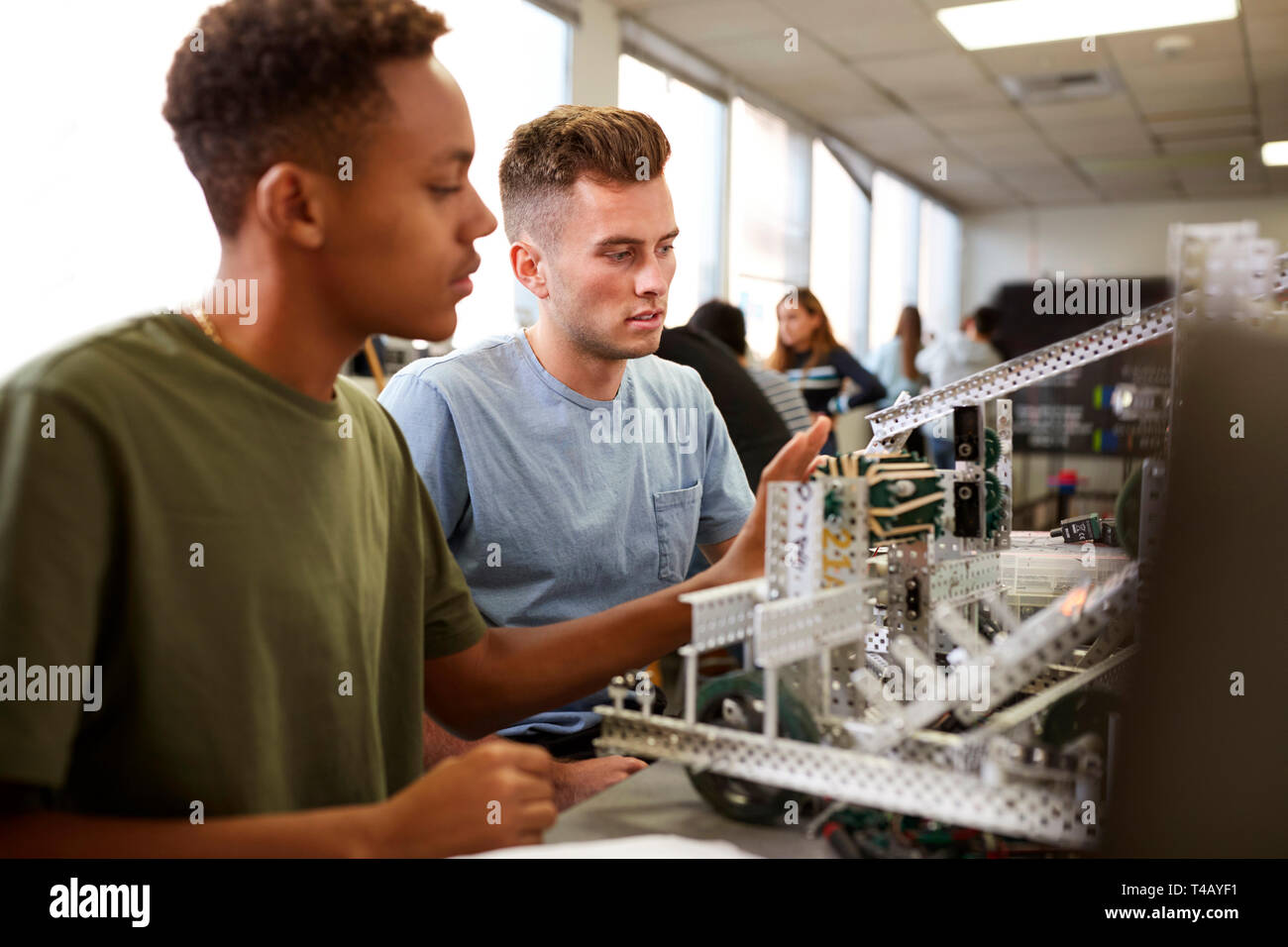 Two Male University Students Building Machine In Science Robotics Or ...