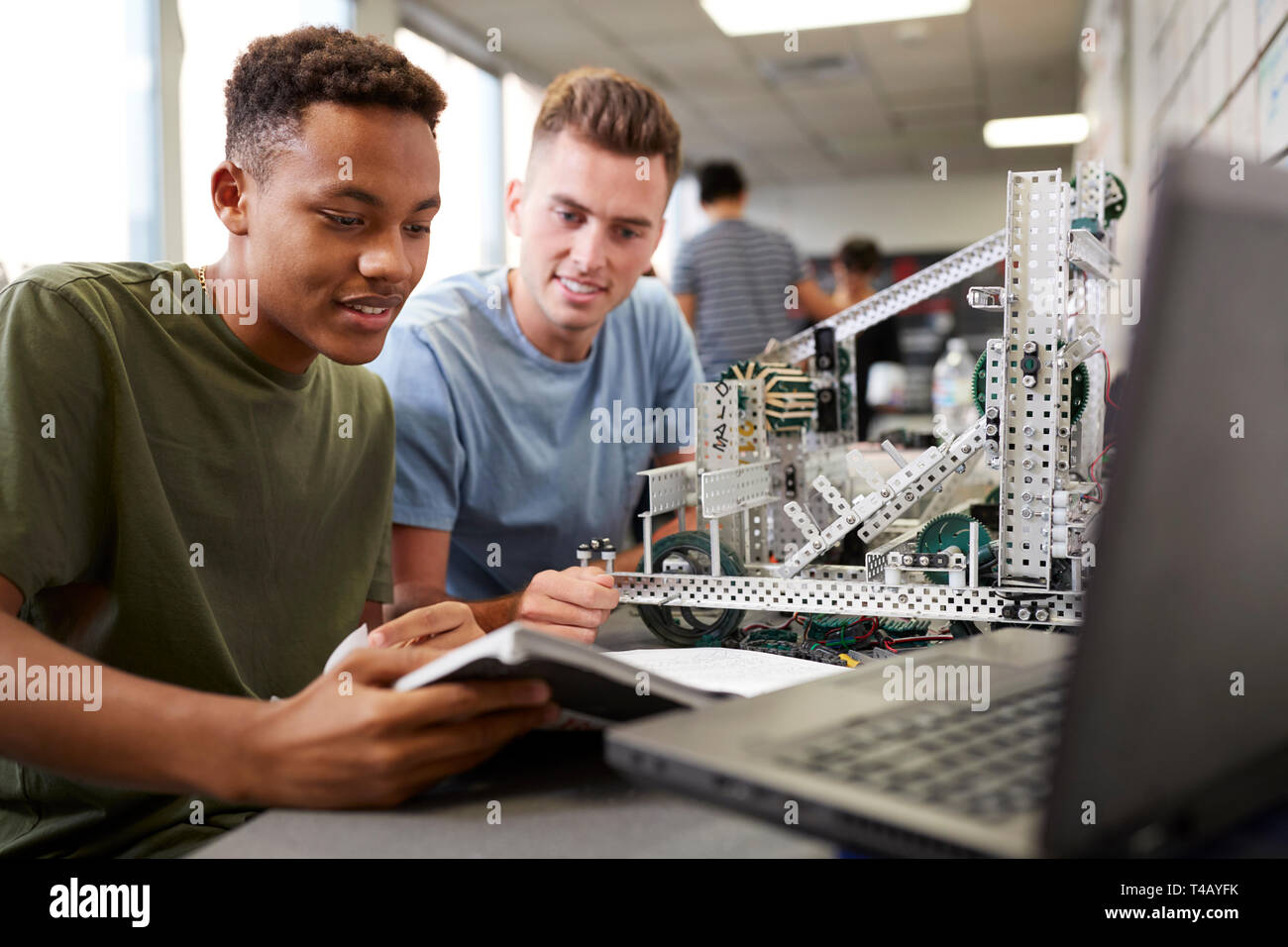 Two Male University Students Building Machine In Science Robotics Or ...
