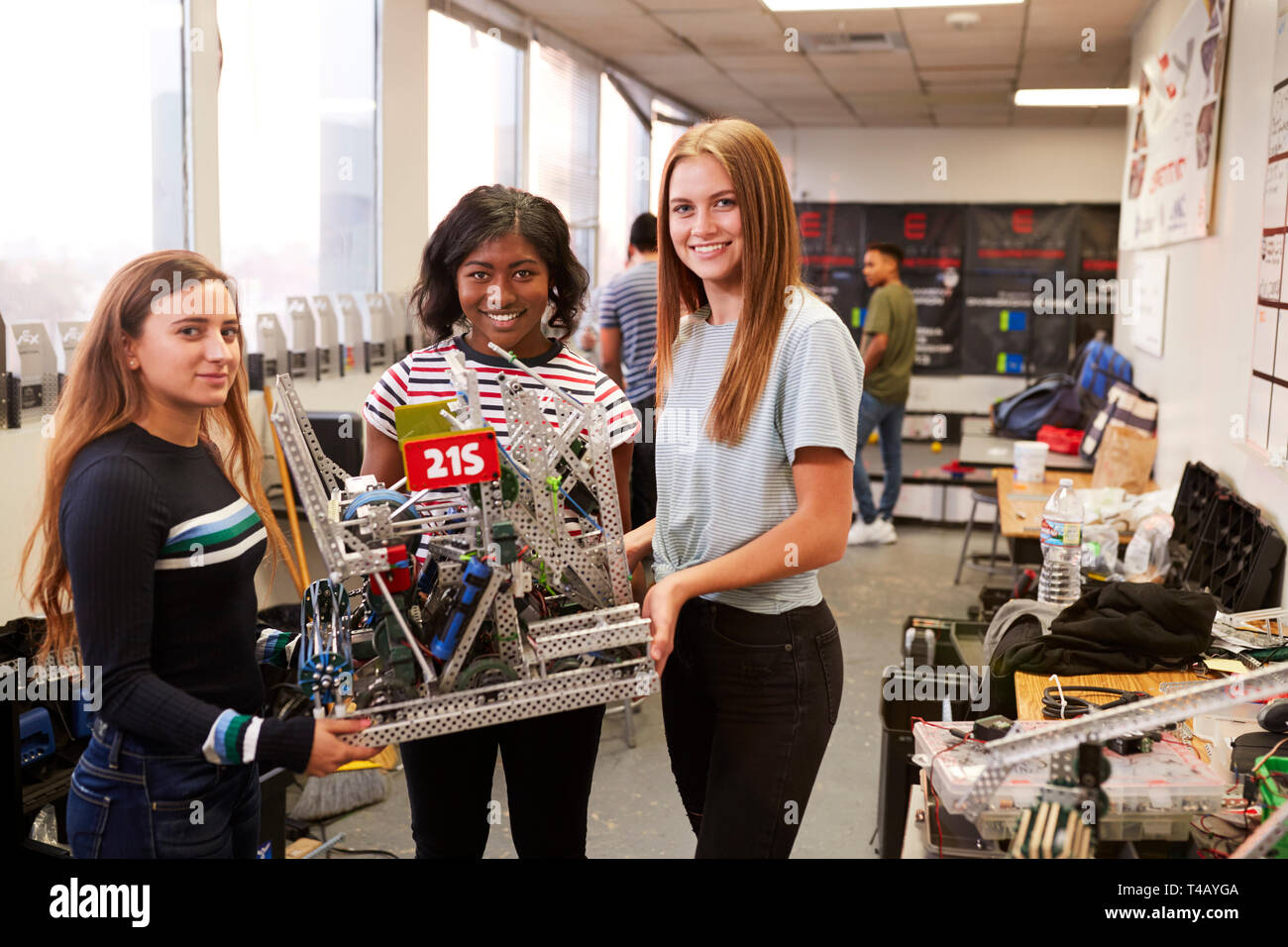 Portrait Of Female University Students Carrying Machine In Science ...