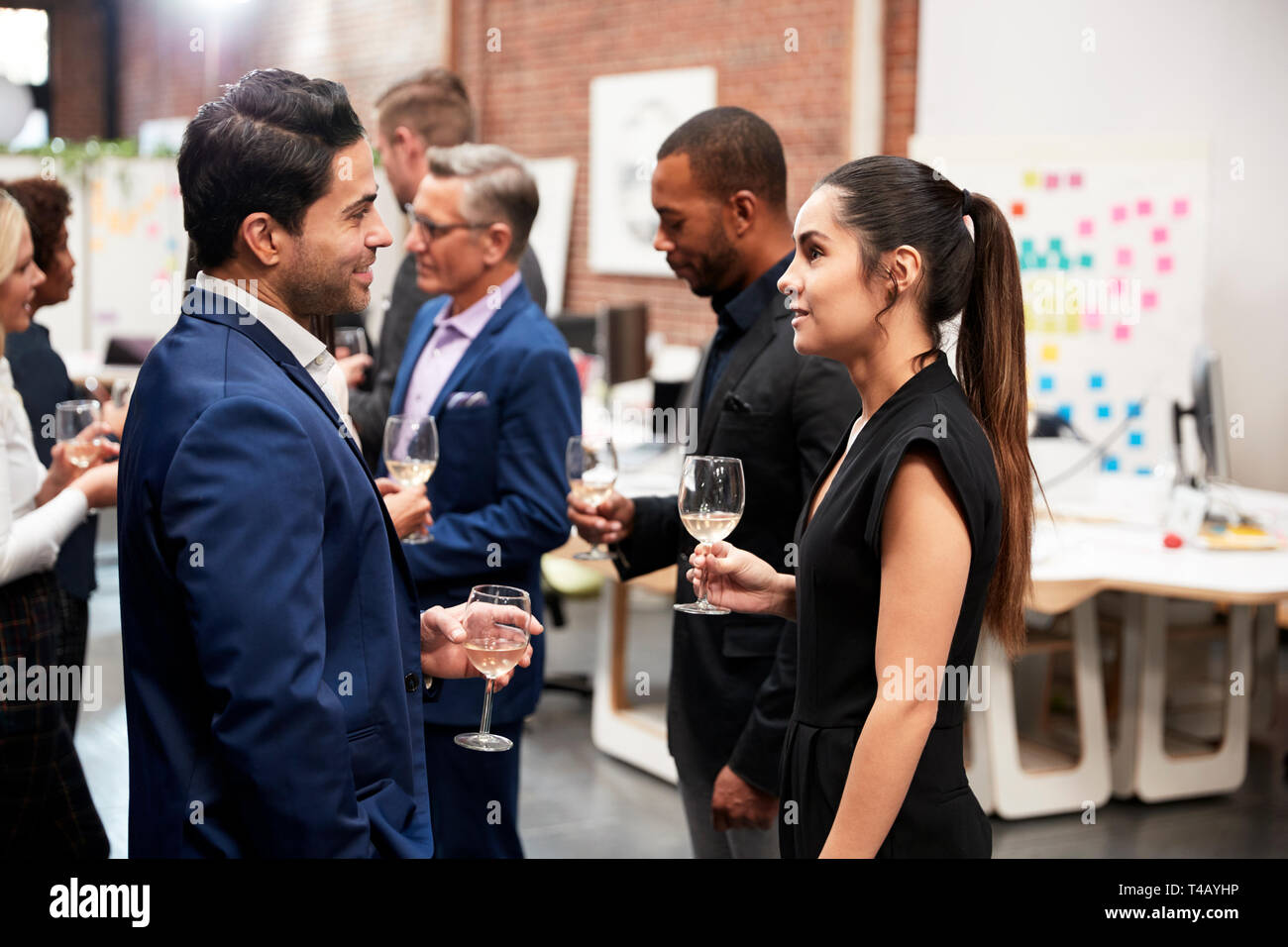 Business Team Socializing At After Works Drinks In Modern Office Stock ...