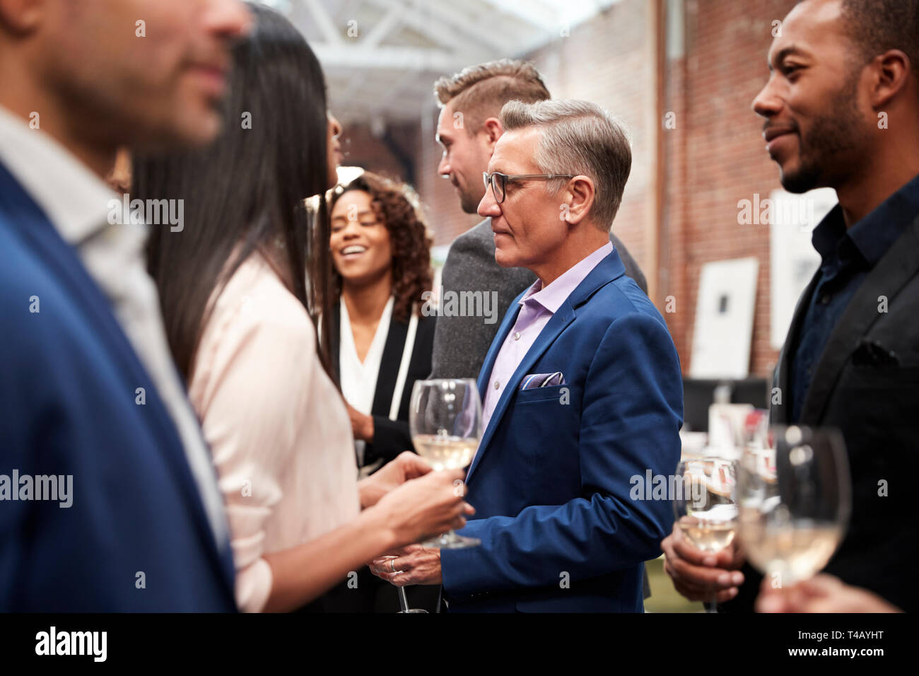 Business Team Socializing At After Works Drinks In Modern Office Stock ...