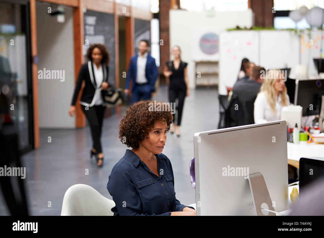 Business Team Working At Desks In Modern Open Plan Office Stock Photo ...