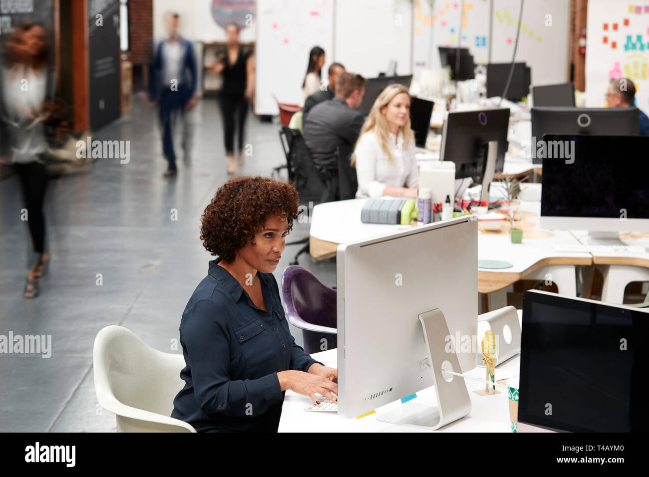 Businesswoman sitting desk in open hi-res stock photography and images ...