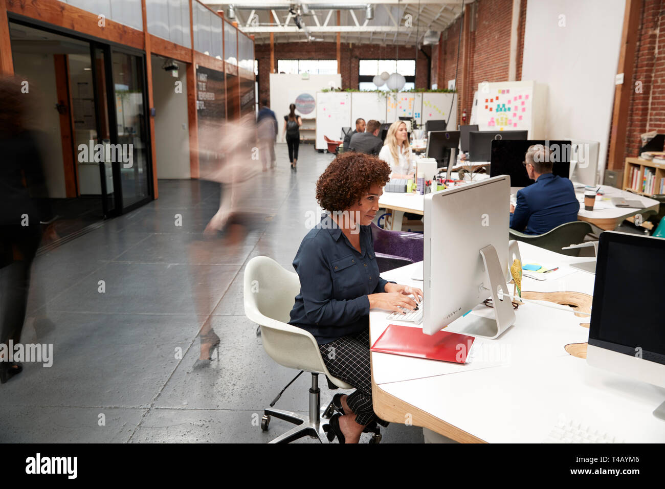 Businesswoman sitting desk in open hi-res stock photography and images ...