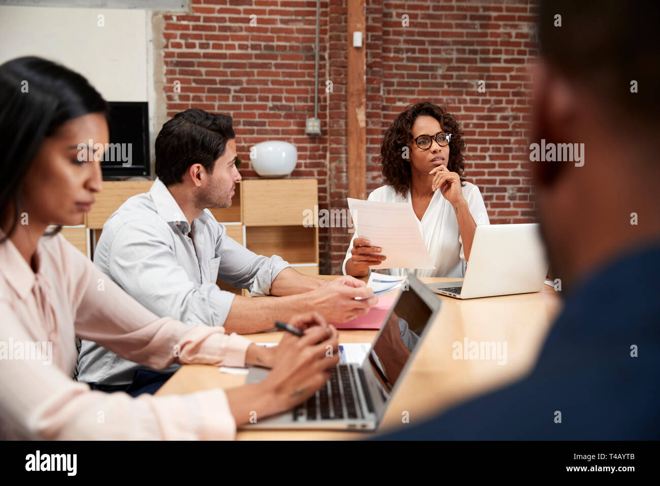 Colleagues collaborating around office table hi-res stock photography ...