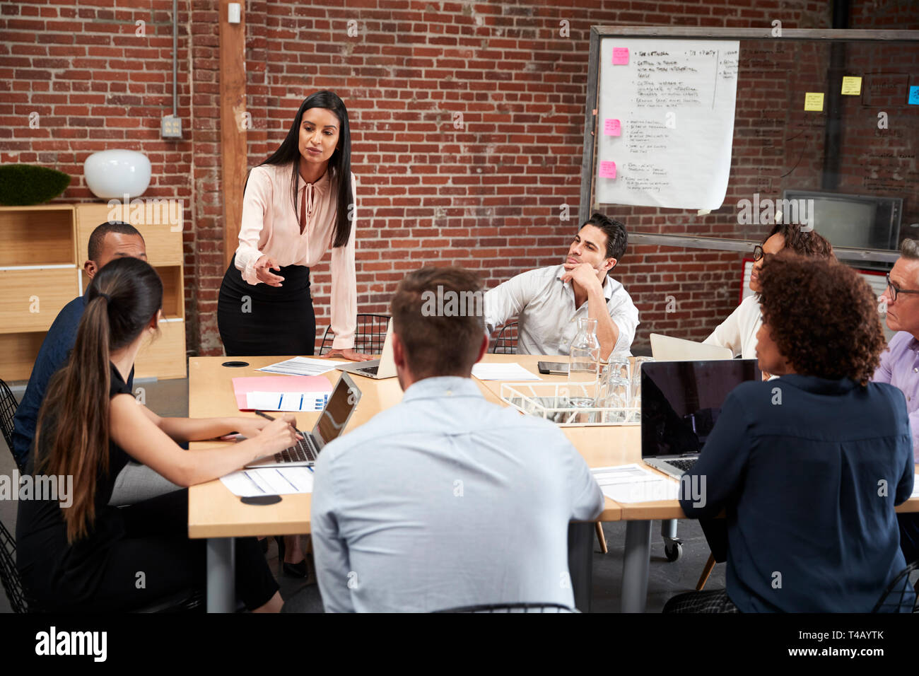 Young businesswoman standing leading office hi-res stock photography ...