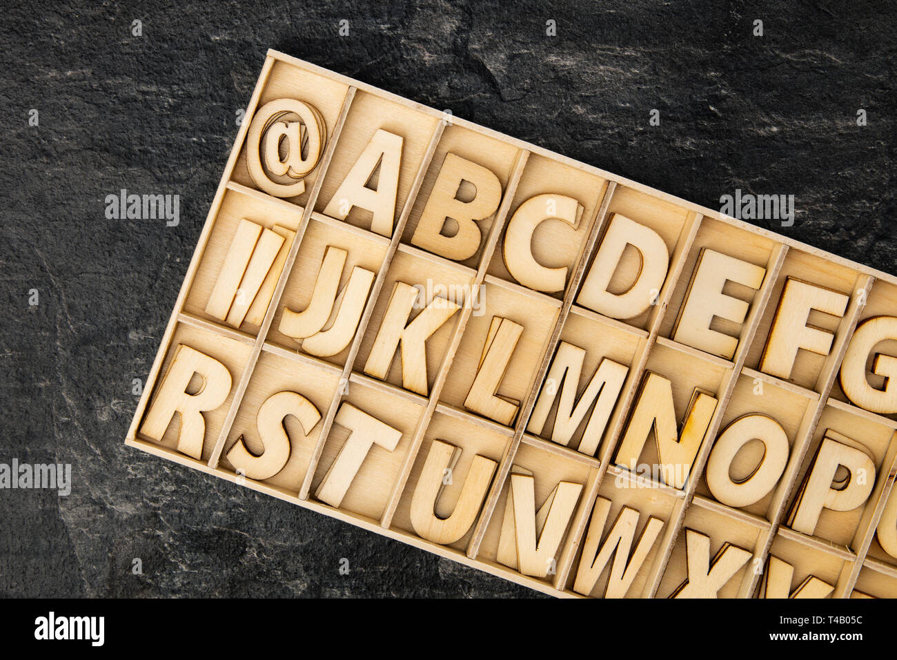 Wooden toy letters in a Box on dark background Stock Photo - Alamy