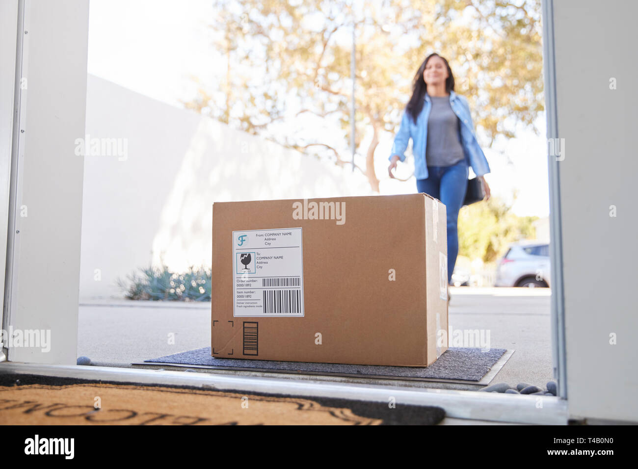 Woman coming in front door hi-res stock photography and images - Alamy