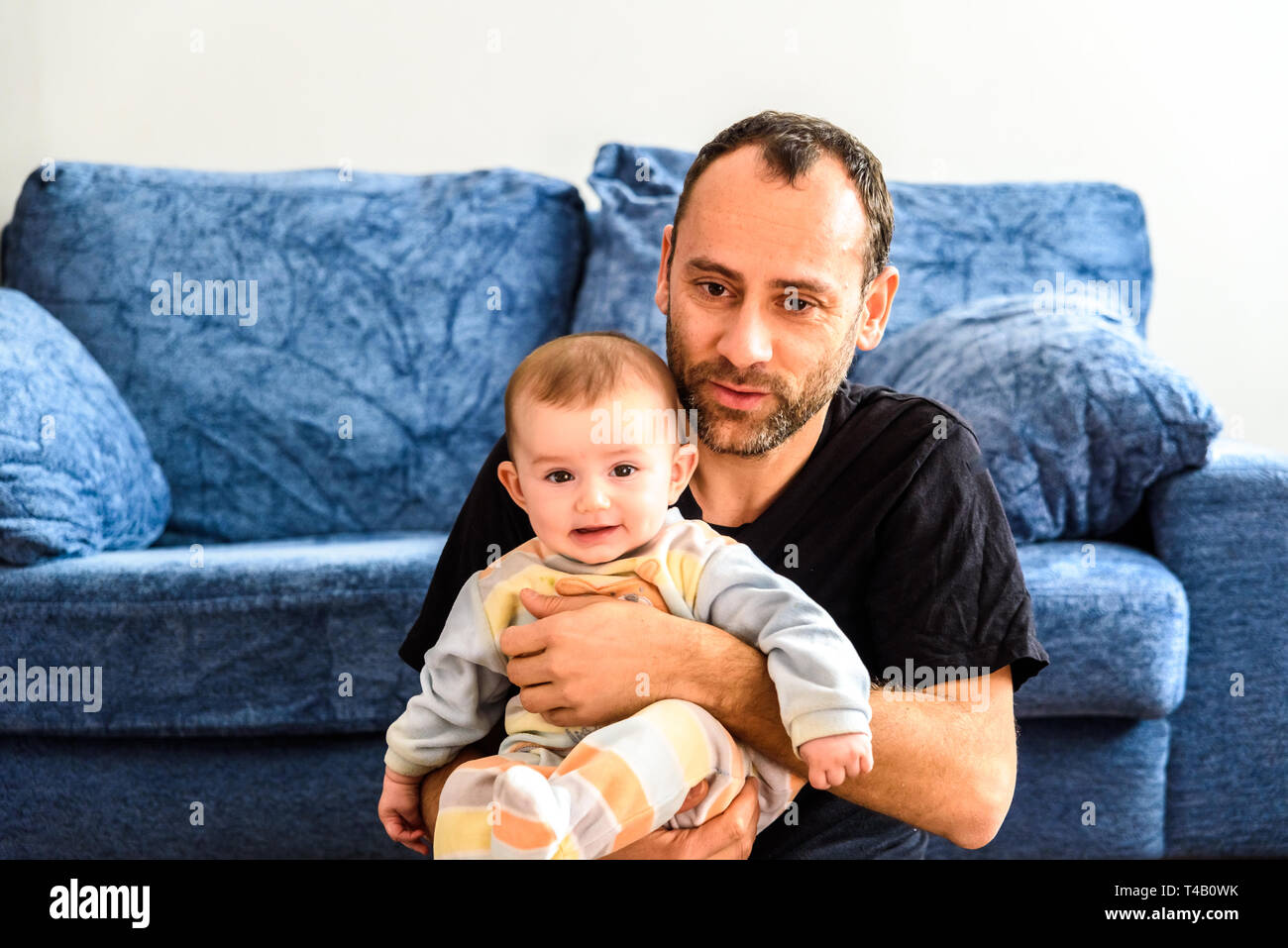 Dad hugging his baby daughter lovingly Stock Photo - Alamy