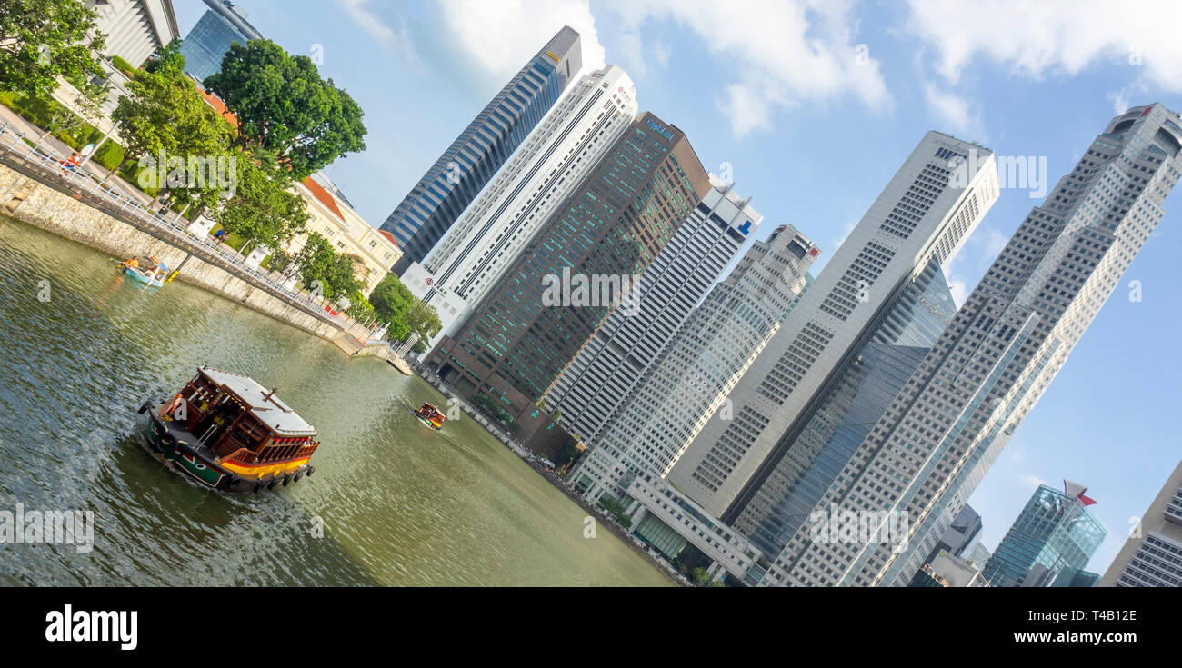 Traditional wooden boat on the Singapore River in downtown Singapore ...