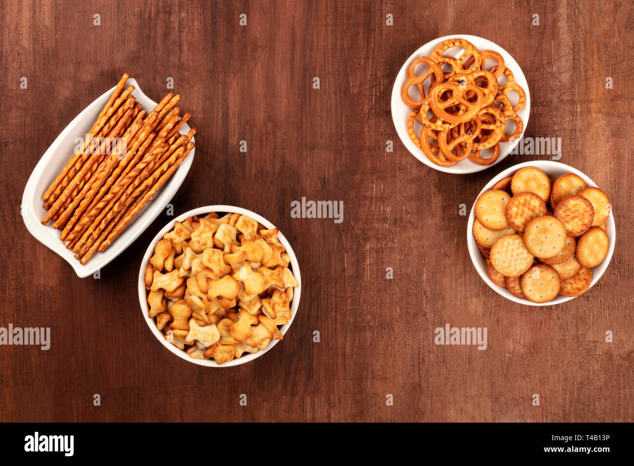 Salt crackers, sticks, pretzels, and goldfishes, shot from the top on a ...