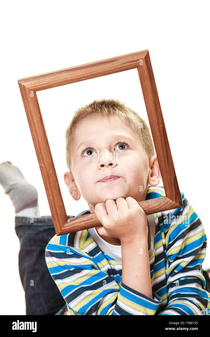 Portrait of little funny blonde boy child holding photo frame framing ...