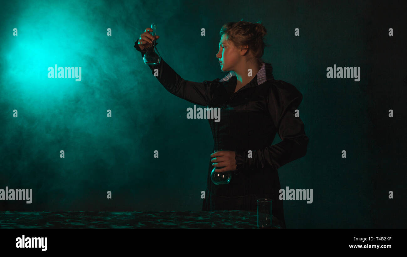 Scientist researcher with a flask of radioactive material. The study of ...