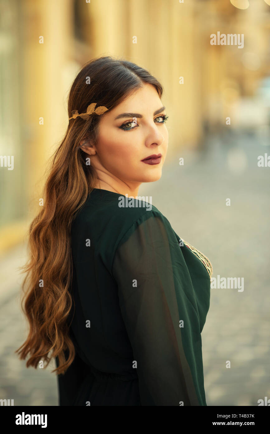 Beautiful woman looking over shoulder Stock Photo - Alamy