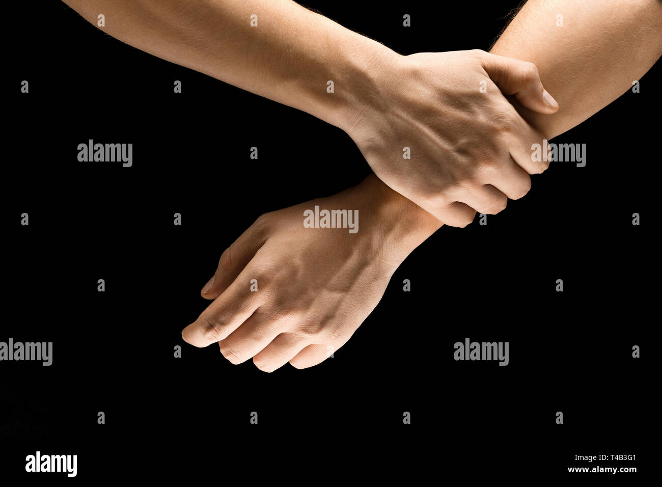 Doubt and uncertainty. Male hands demonstrating a self holding gesture ...