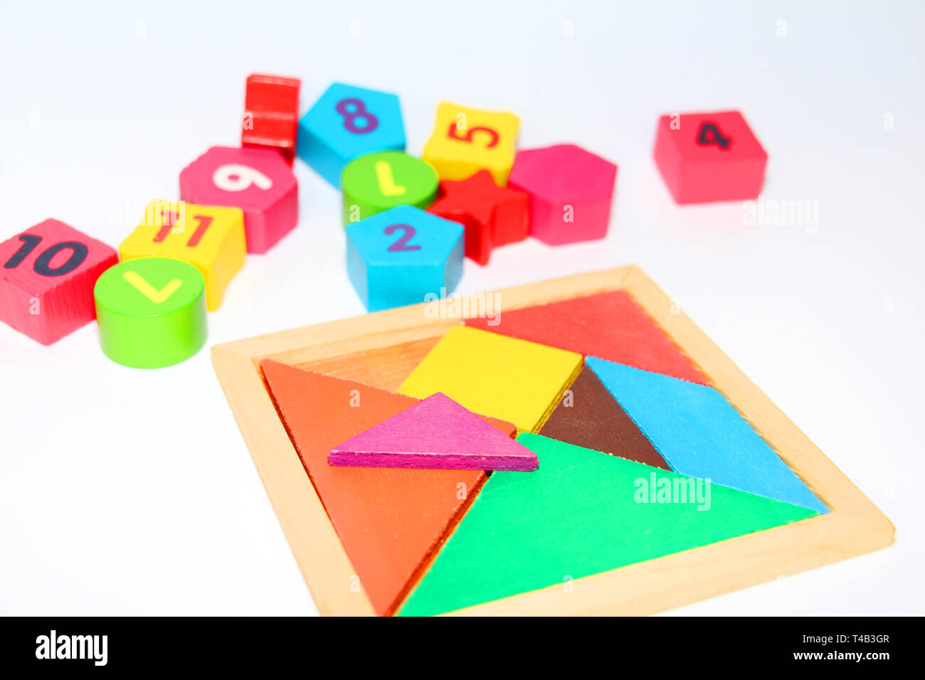 Multi-colored cubes and figures with numbers laid out randomly on a ...