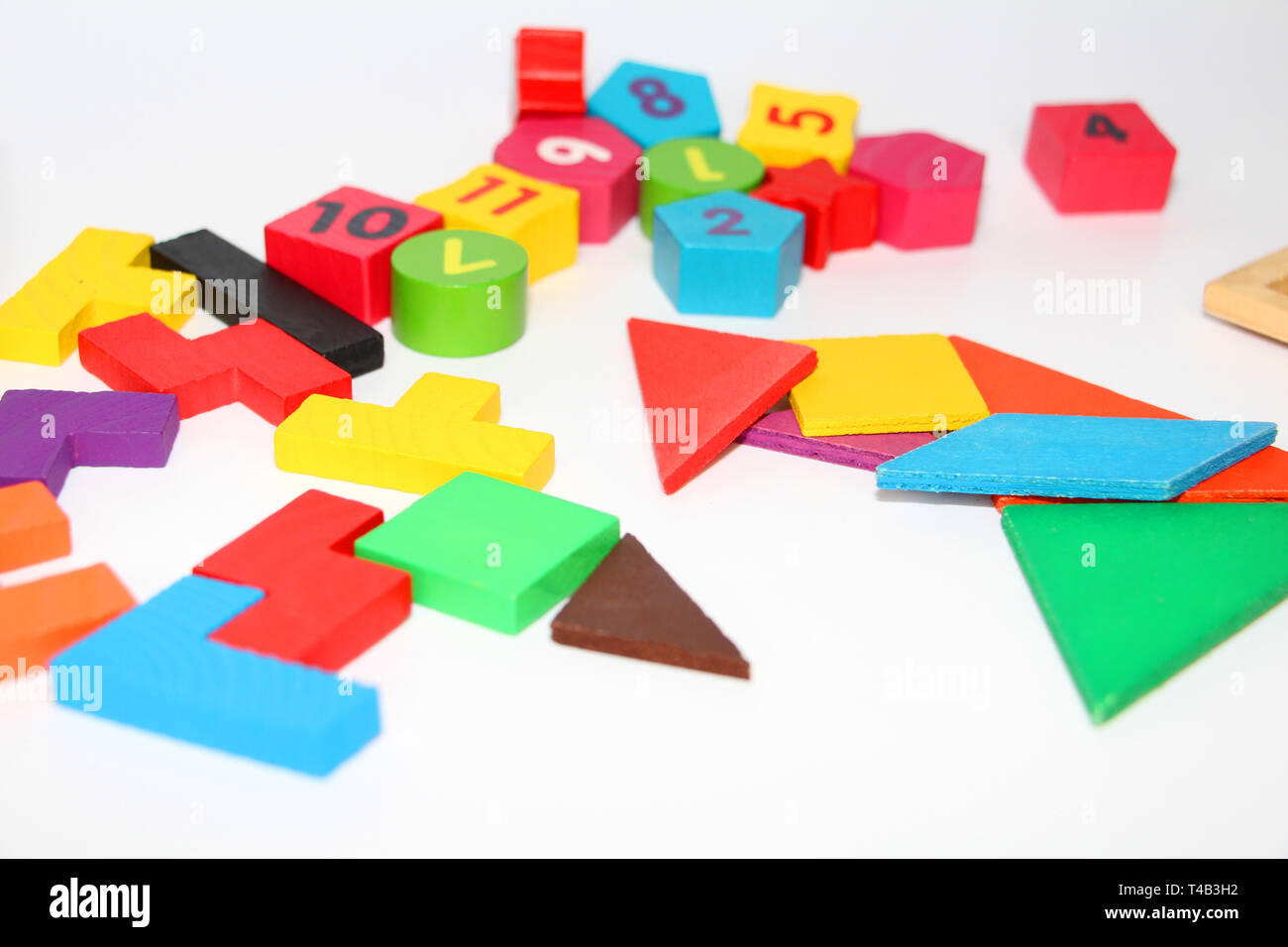 Multi-colored cubes and figures with numbers laid out randomly on a ...
