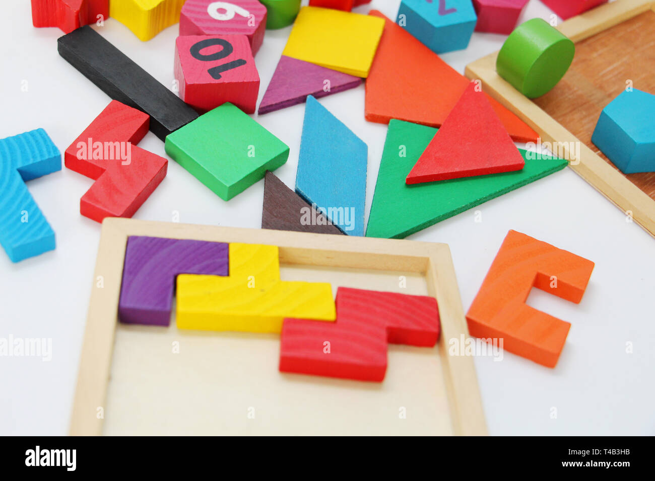 Multi-colored cubes and figures with numbers laid out randomly on a ...