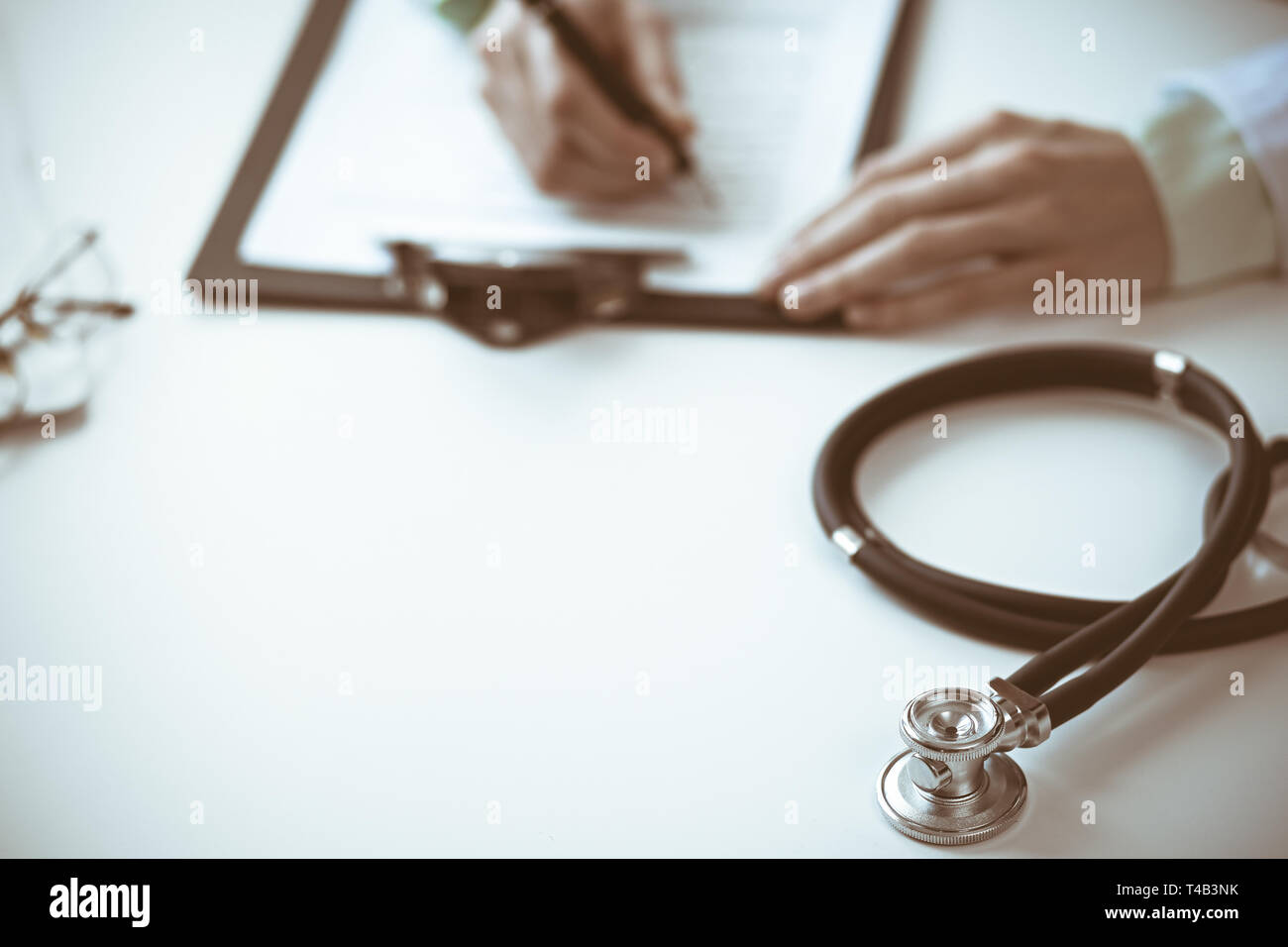 Stethoscope at doctor workplace desk. Physician woman working with ...