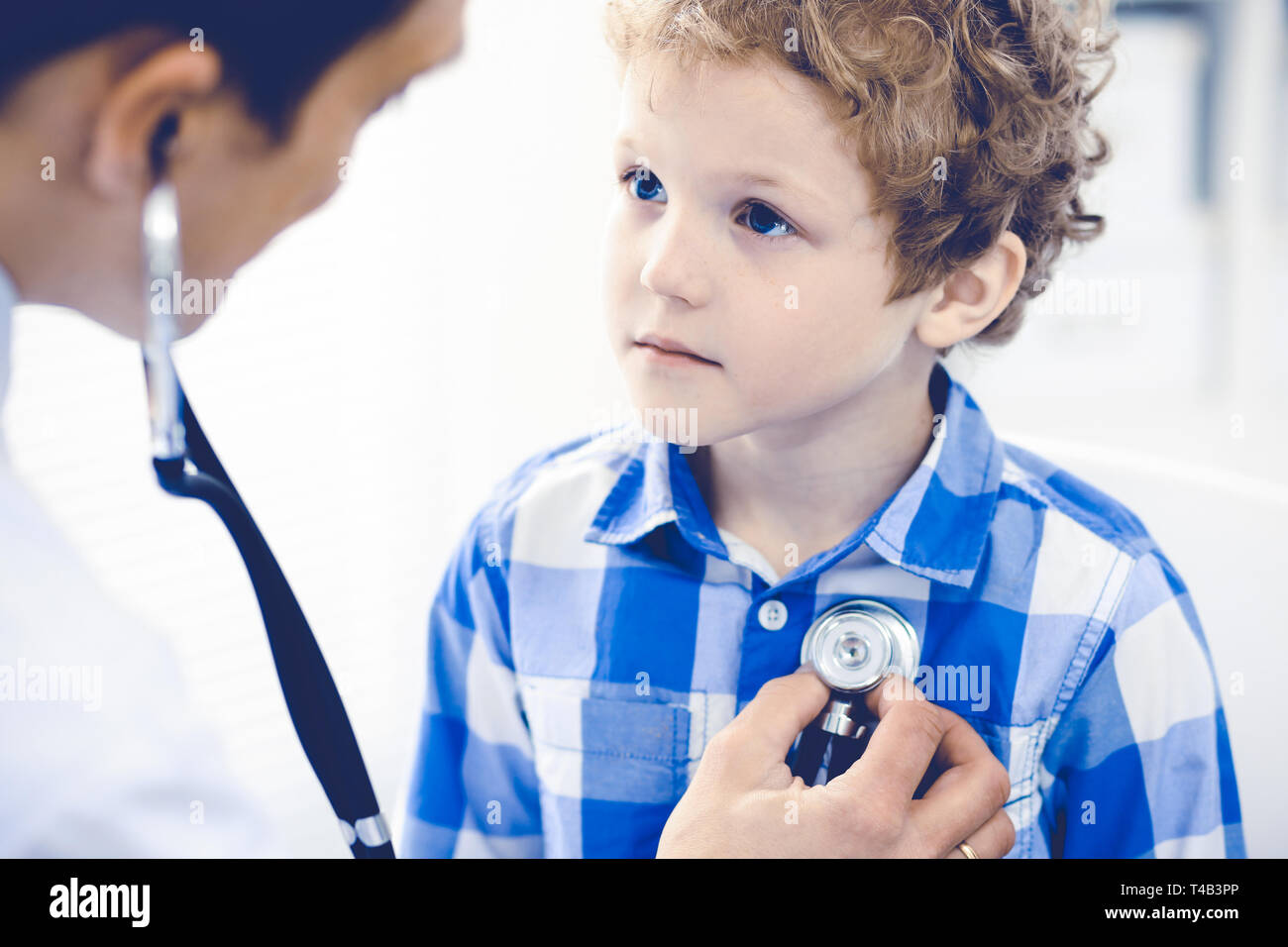 Doctor and patient child. Physician examining little boy. Regular ...