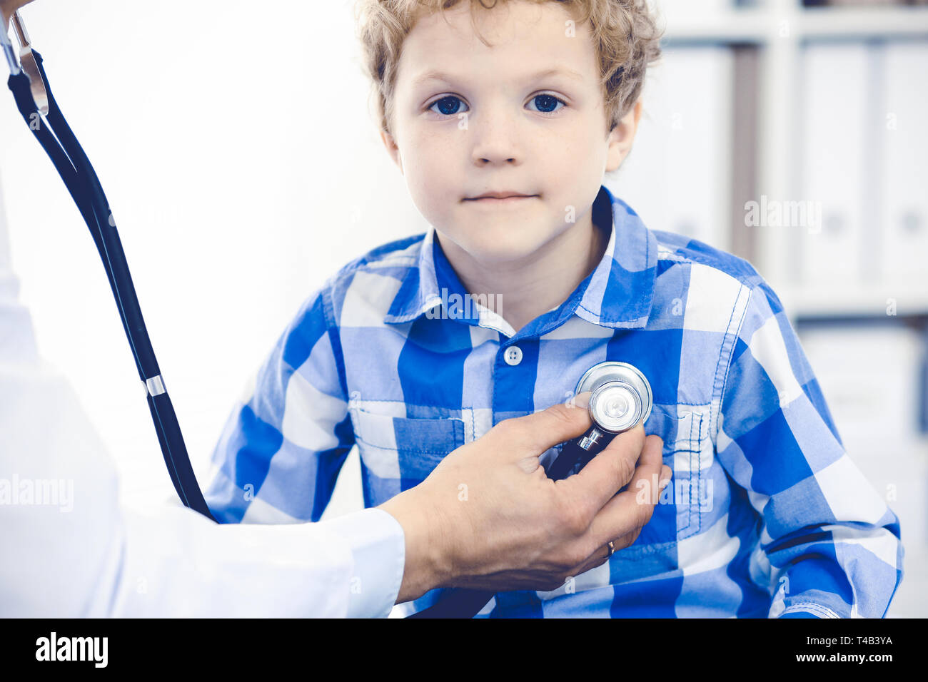 Doctor and patient child. Physician examining little boy. Regular ...