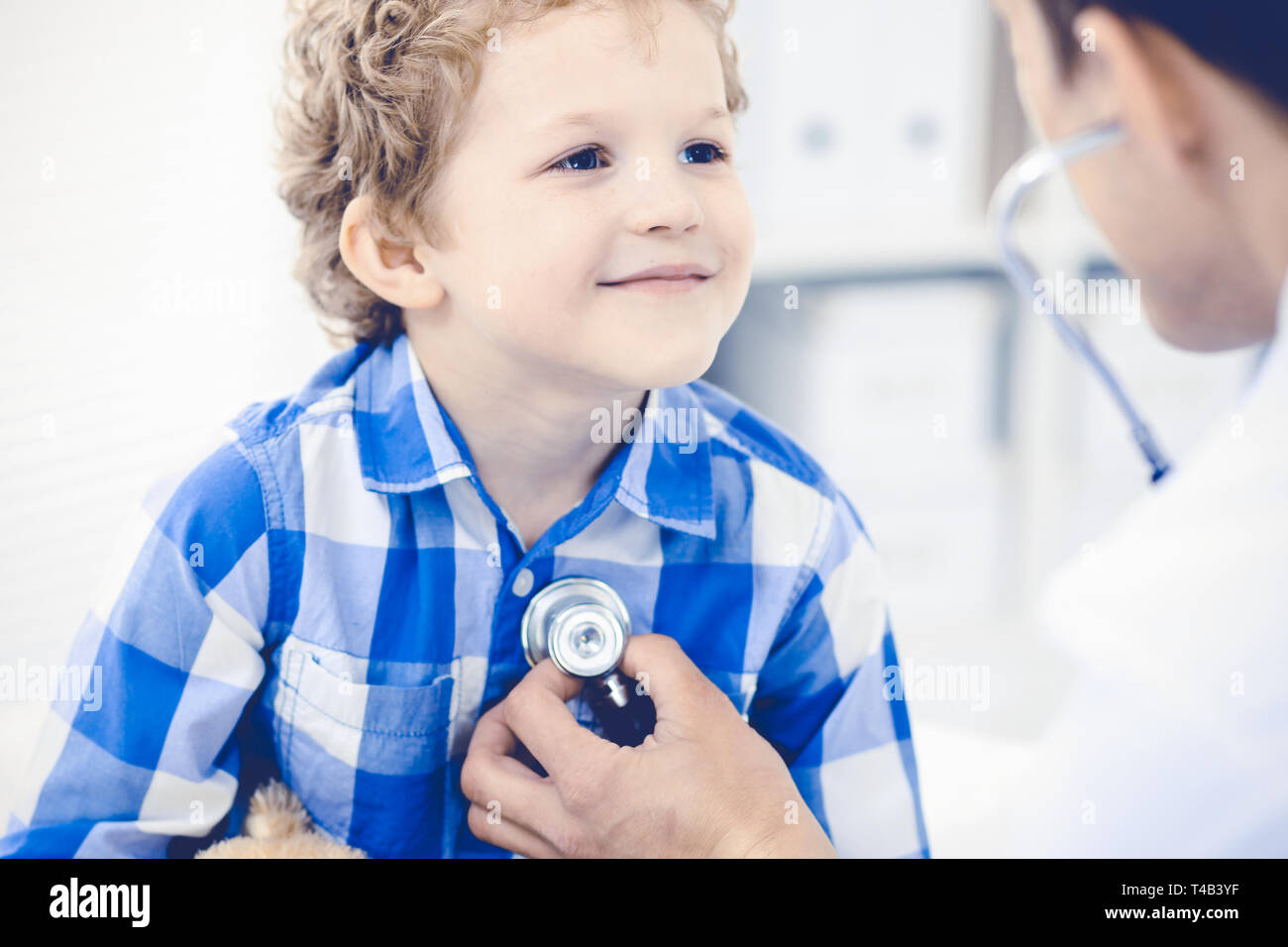 Doctor and patient child. Physician examining little boy. Regular ...