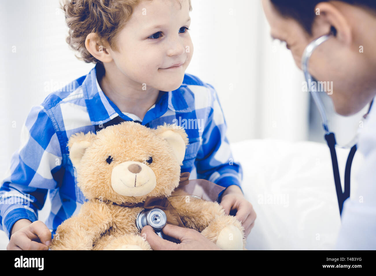 Doctor and patient child. Physician examining little boy. Regular ...