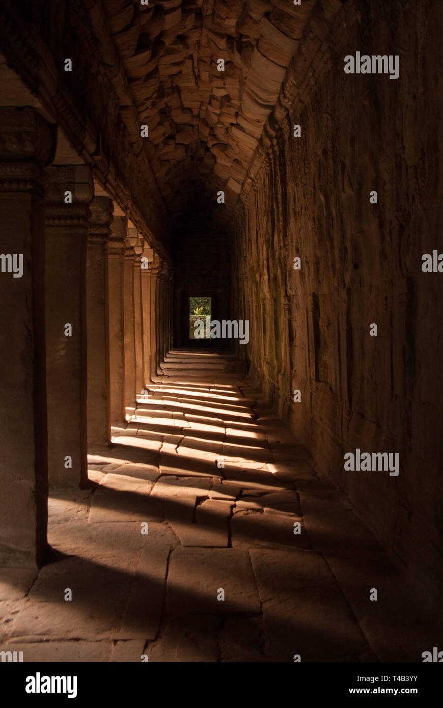 Arcade in a temple close to Angkor Wat in Cambodia with the morning sun ...