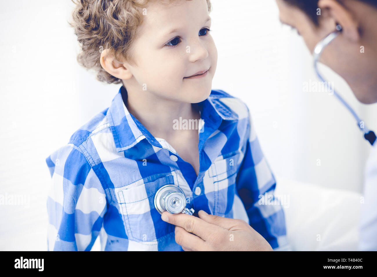 Doctor and patient child. Physician examining little boy. Regular ...