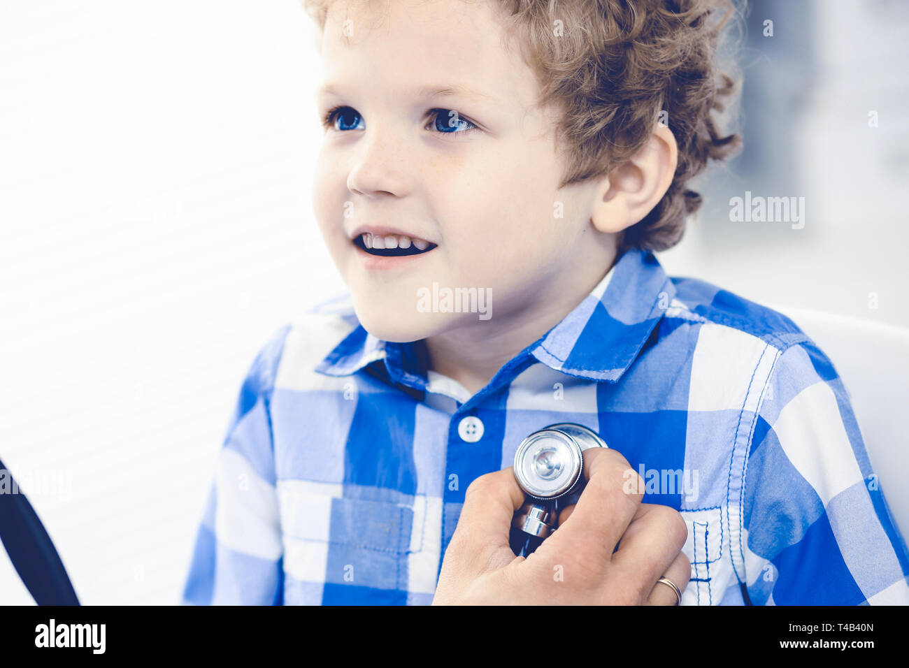 Doctor and patient child. Physician examining little boy. Regular ...