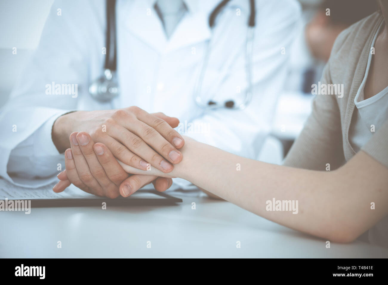Hand of doctor reassuring her female patient. Medicine and health care ...