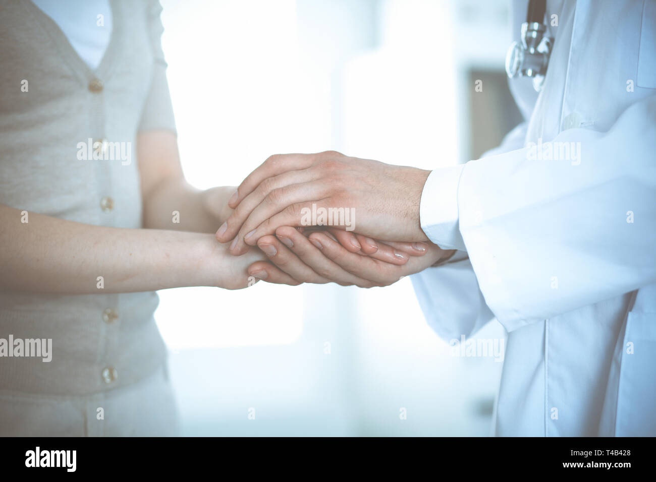 Hand of doctor reassuring her female patient. Medicine and health care ...