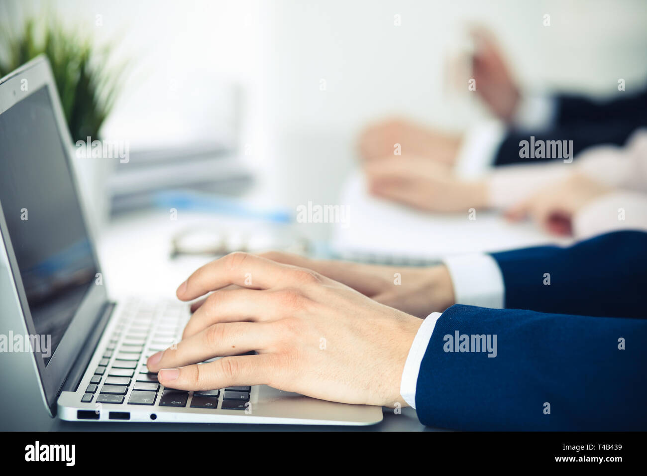 Group of business people working together in office. Man hands typing ...