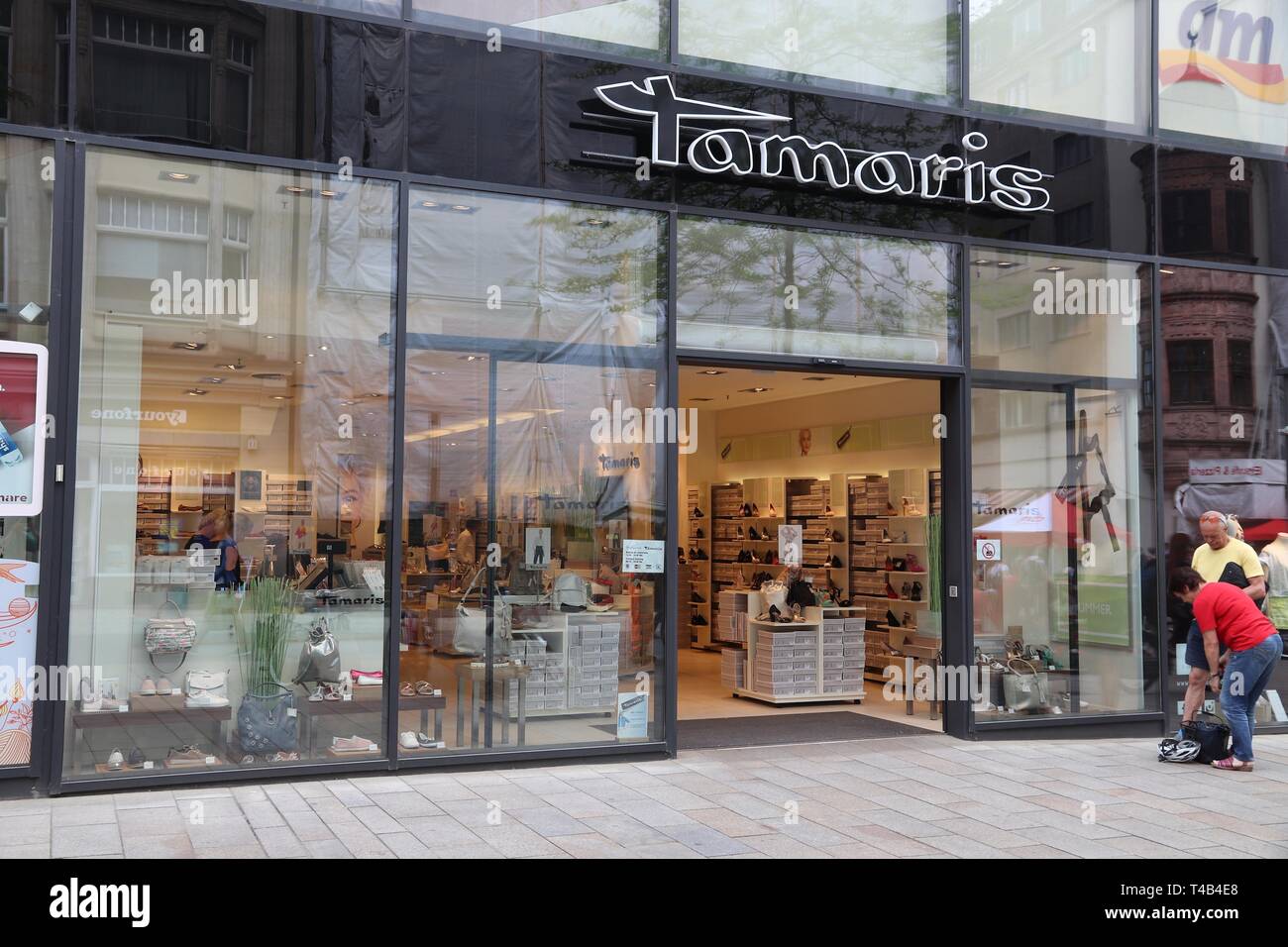 LEIPZIG, GERMANY - MAY 9, 2018: People walk by Tamaris shoe store at ...
