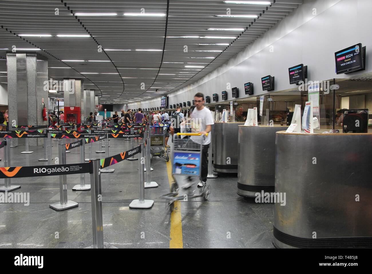 RIO DE JANEIRO, BRAZIL - OCTOBER 19, 2014: Travelers check in at Galeao ...